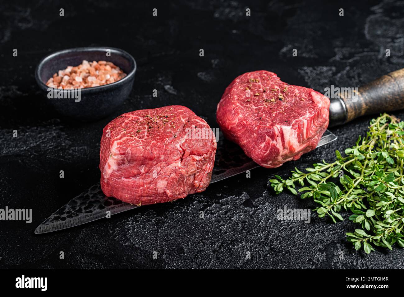 Fillet Mignon Beef steak, raw dry aged marble meat. Black background ...