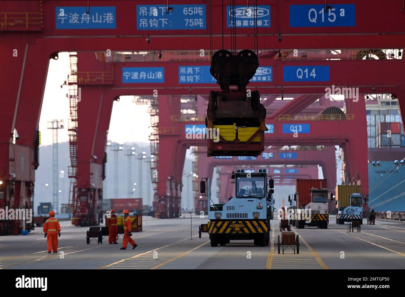 Ningbo. 31st Jan, 2023. Cranes and trucks work at a container terminal ...
