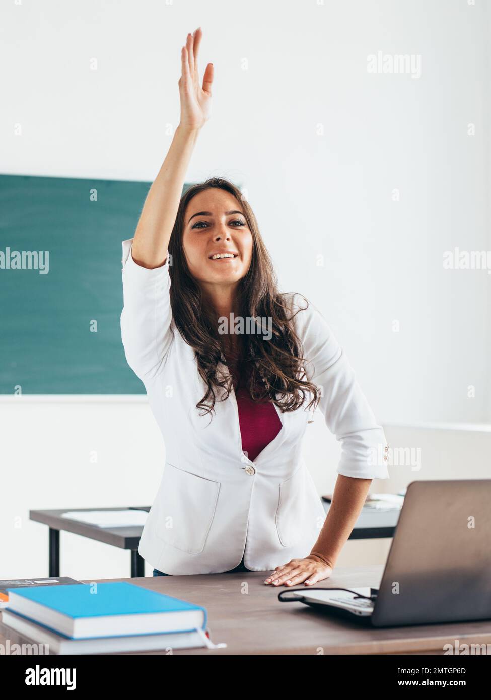 Woman raise hand desk hi-res stock photography and images - Alamy
