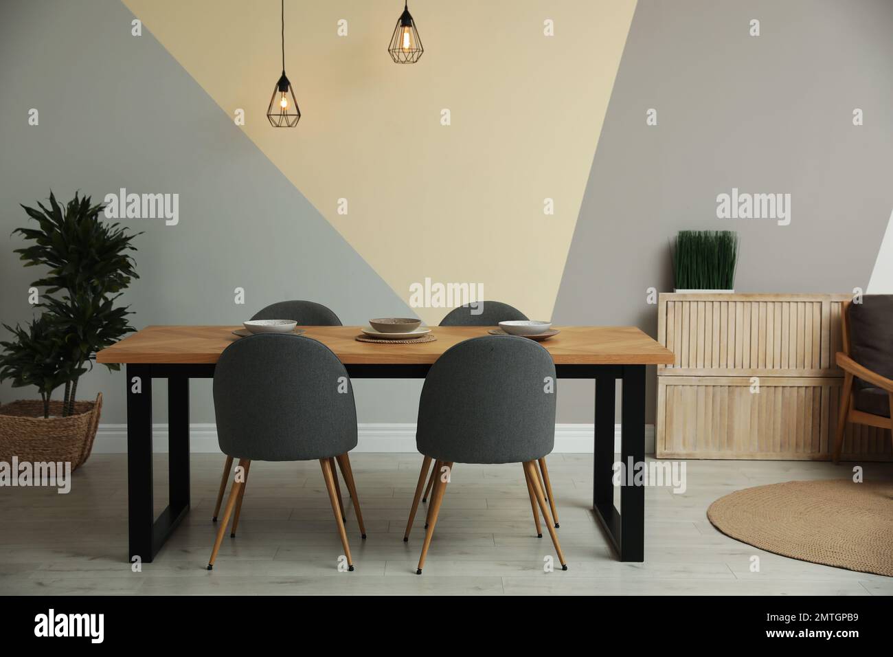 Modern wooden dining table in room interior Stock Photo - Alamy