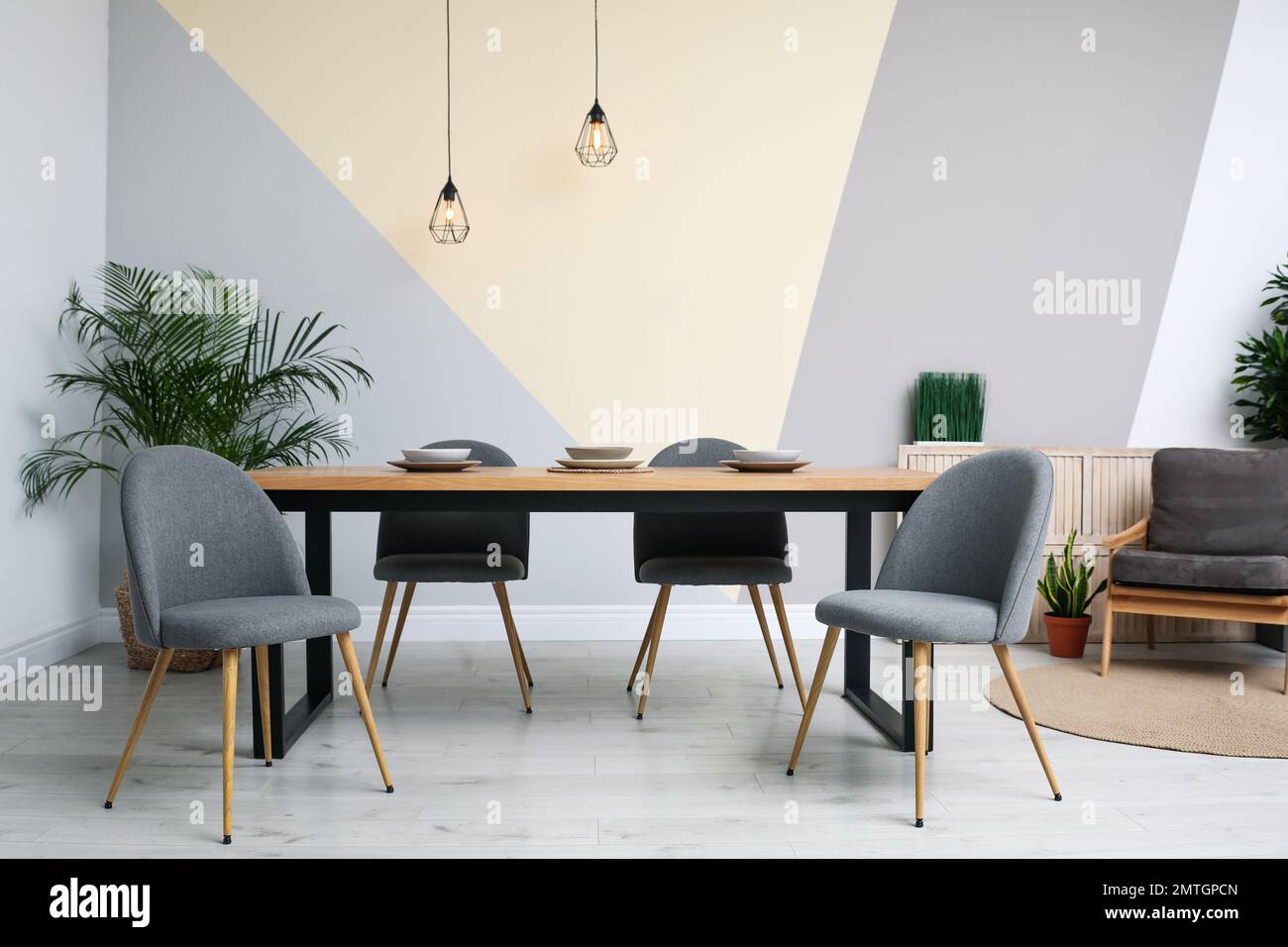 Modern wooden dining table in room interior Stock Photo - Alamy