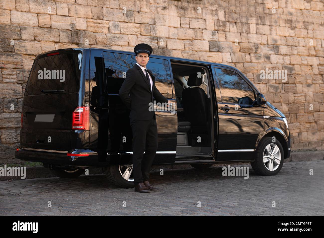 Driver opening door of luxury car on street. Chauffeur service Stock ...