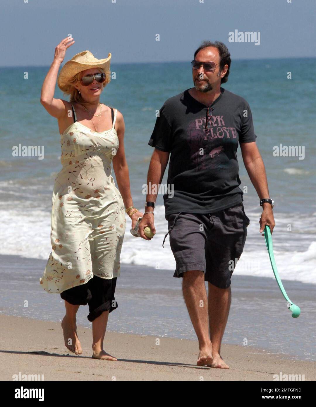 Rosanna Arquette takes a stroll on the beach with a friend while ...