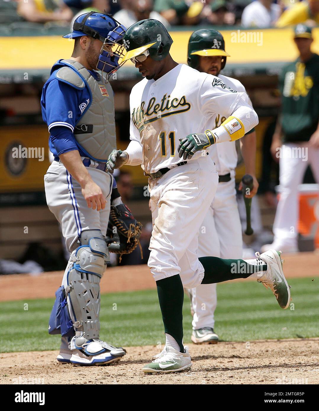 Oakland Athletics' Rajai Davis (11) scores in front of Toronto Blue ...