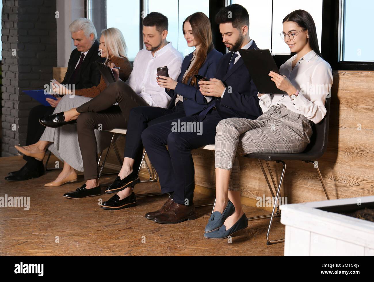People waiting for job interview in office hall Stock Photo - Alamy