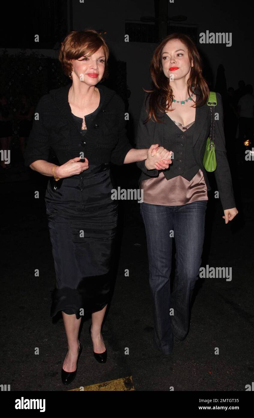 Actress Rose McGowan holds hands with her mother as they leave the restaurant Beso with Robert ...