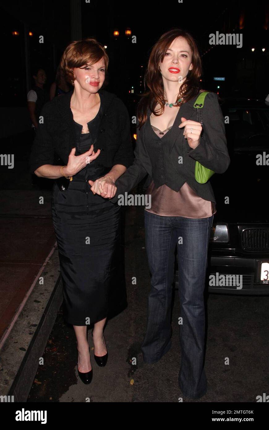 Actress Rose McGowan holds hands with her mother as they leave the restaurant Beso with Robert ...
