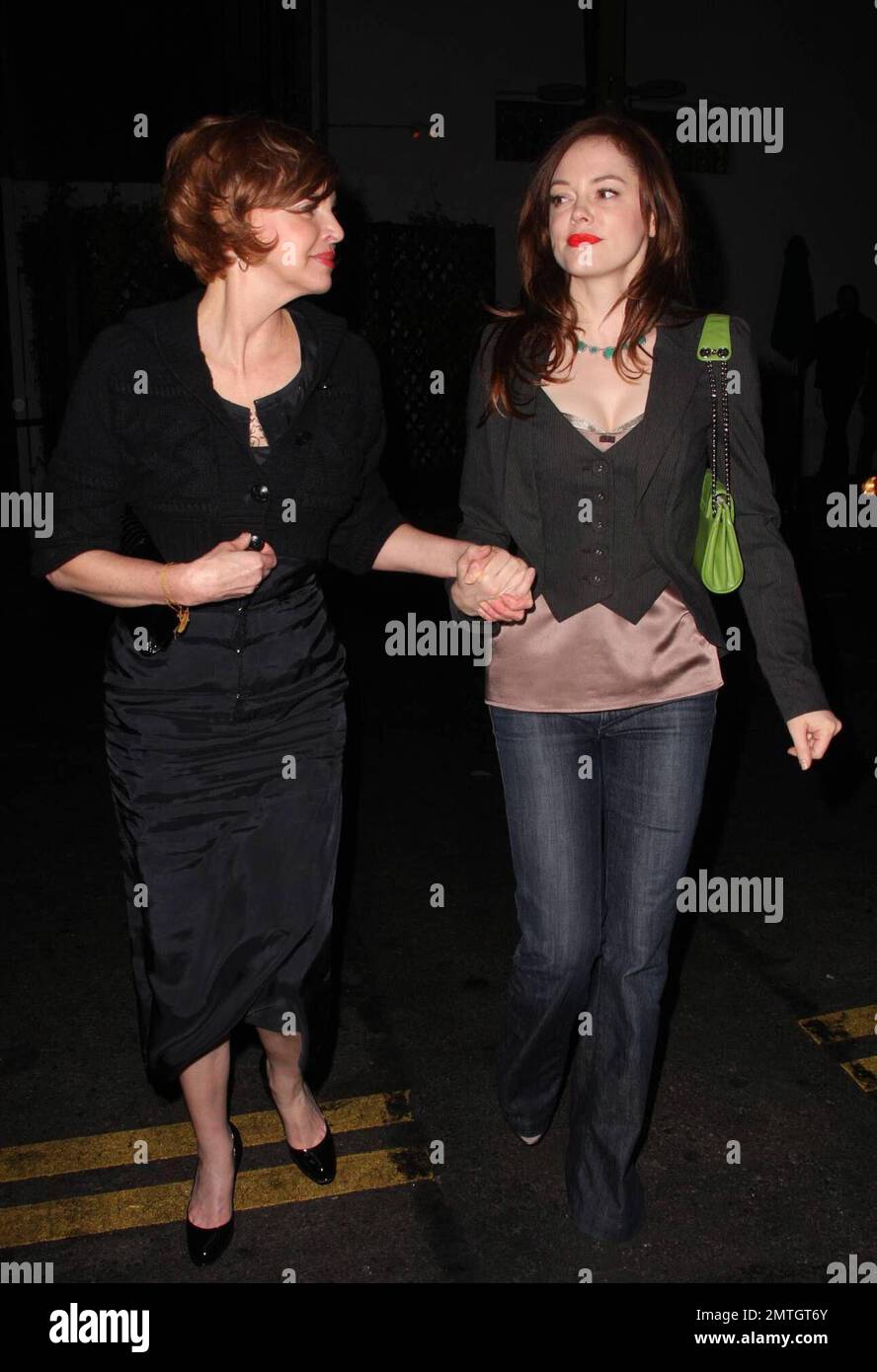 Actress Rose McGowan holds hands with her mother as they leave the restaurant Beso with Robert ...