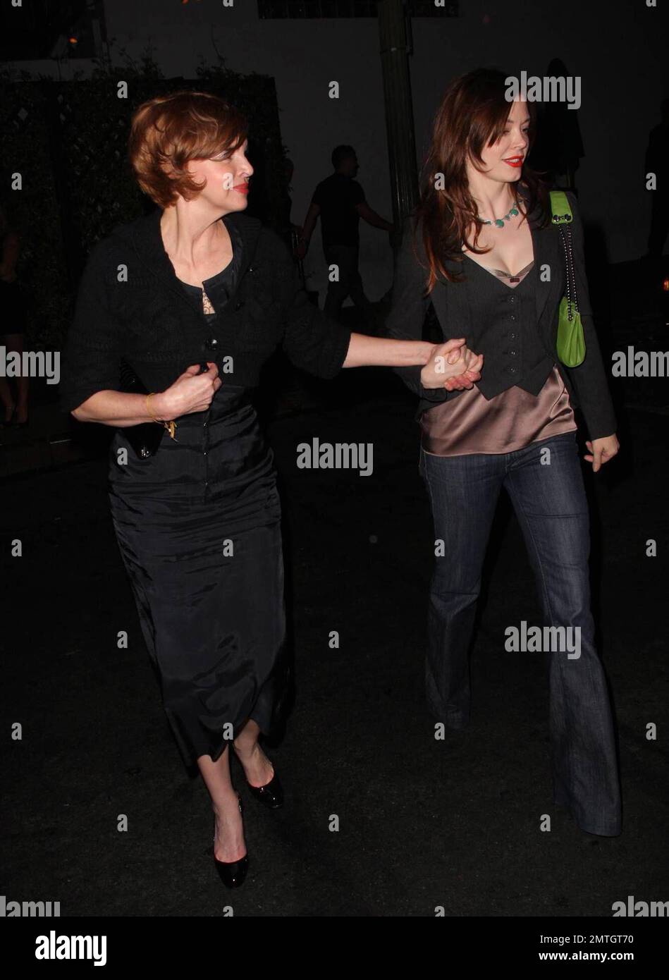Actress Rose McGowan holds hands with her mother as they leave the restaurant Beso with Robert ...