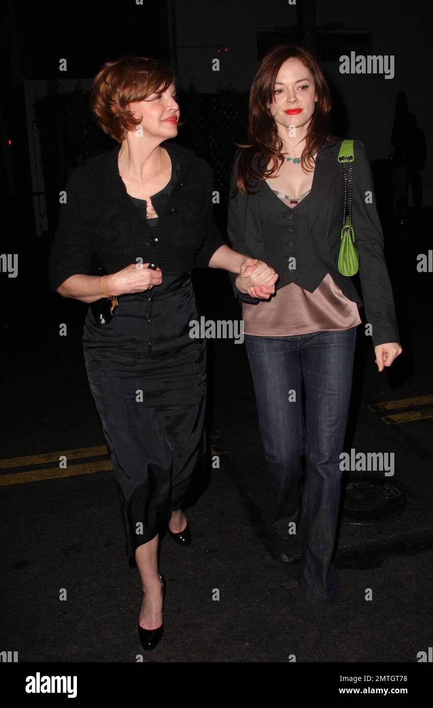 Actress Rose McGowan holds hands with her mother as they leave the restaurant Beso with Robert ...