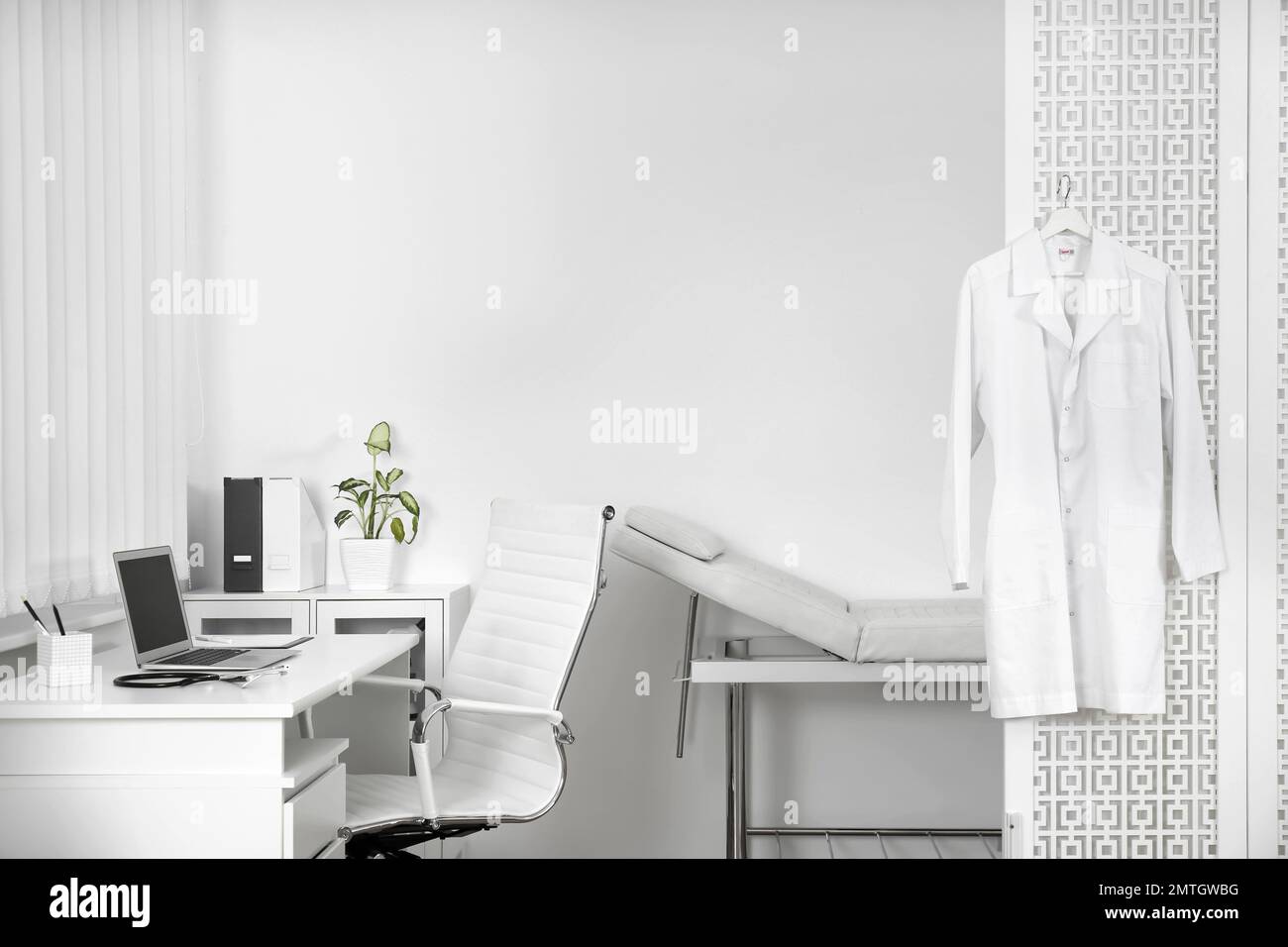 Doctor's office interior with desk and examination couch Stock Photo ...