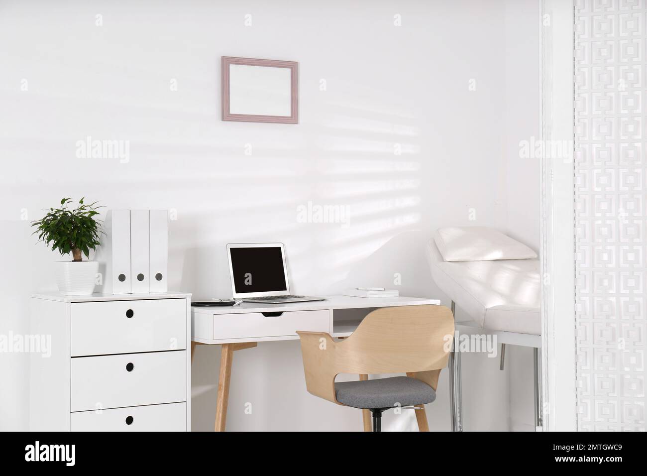 Doctor's office interior with examination couch and desk Stock Photo ...