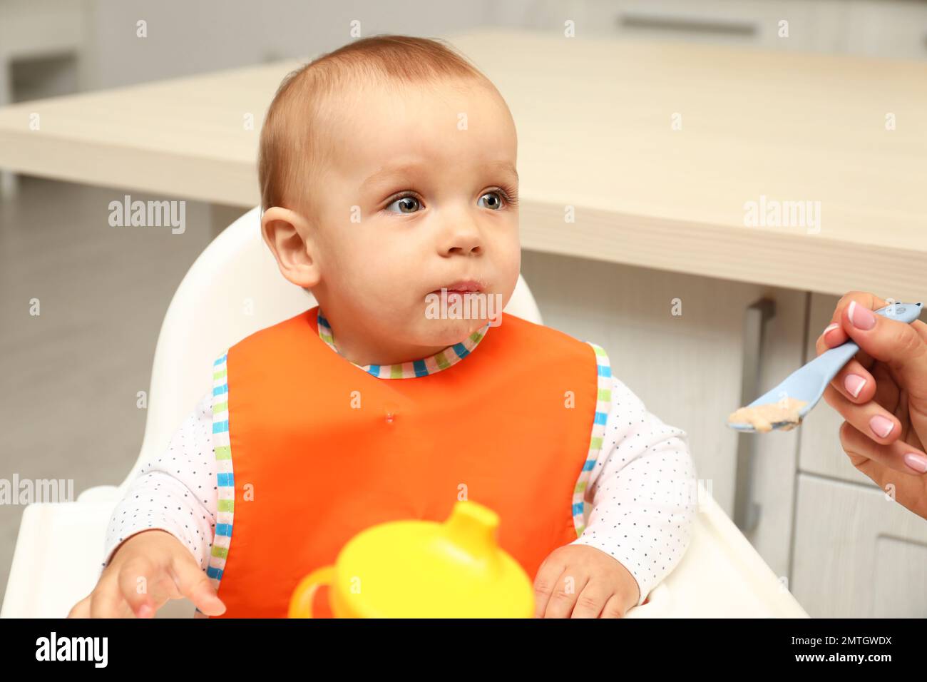 Young mother feeding her little baby at home Stock Photo - Alamy