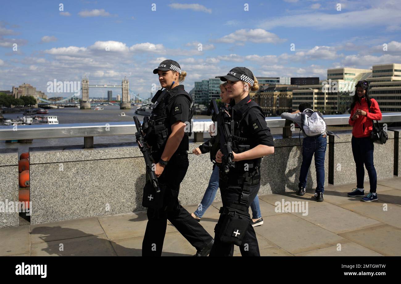 Armed police officers patrol on London Bridge in London, Wednesday ...