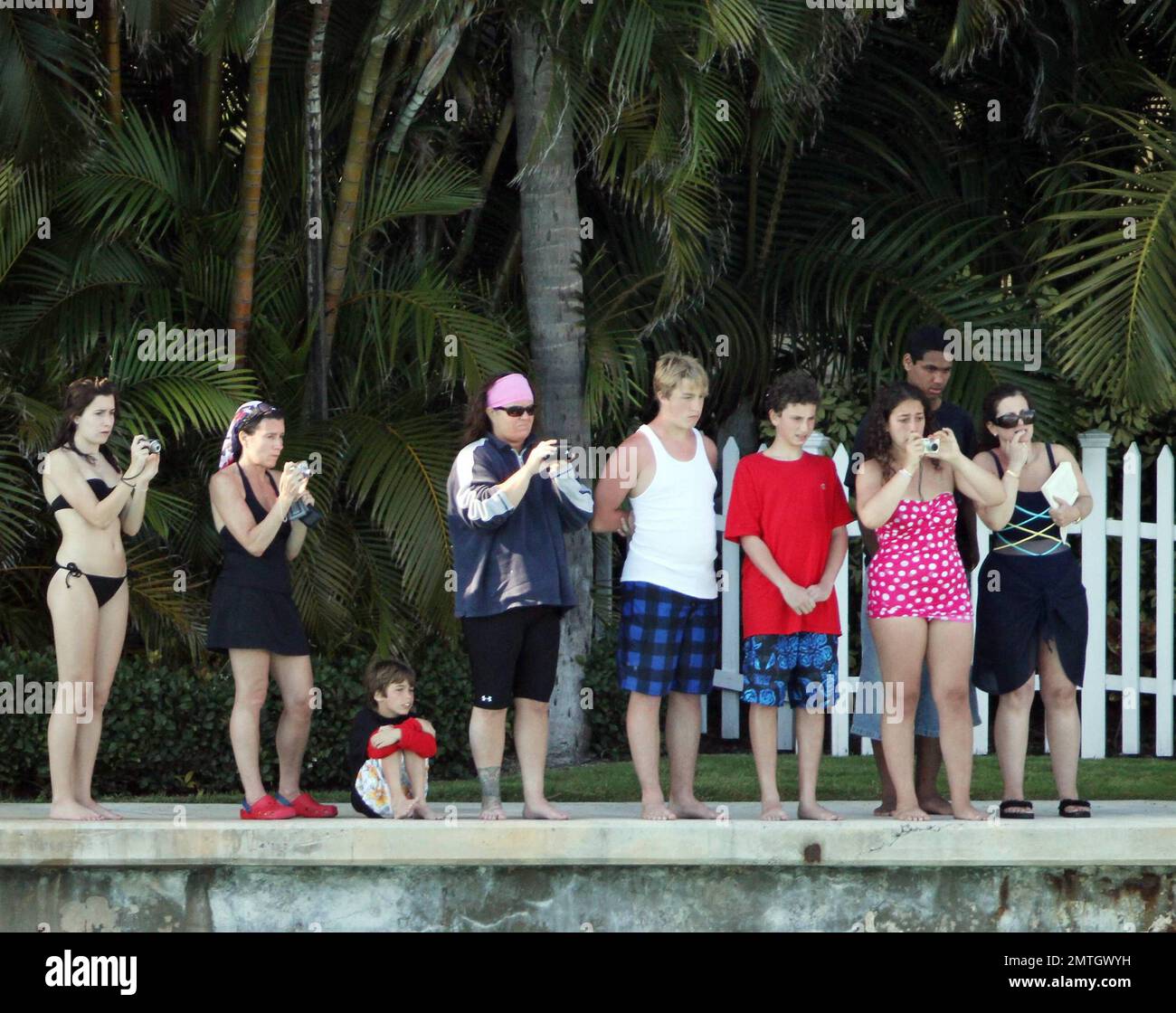 Rosie O'Donnell watches with a large crowd of people as Miami Dade Fire ...