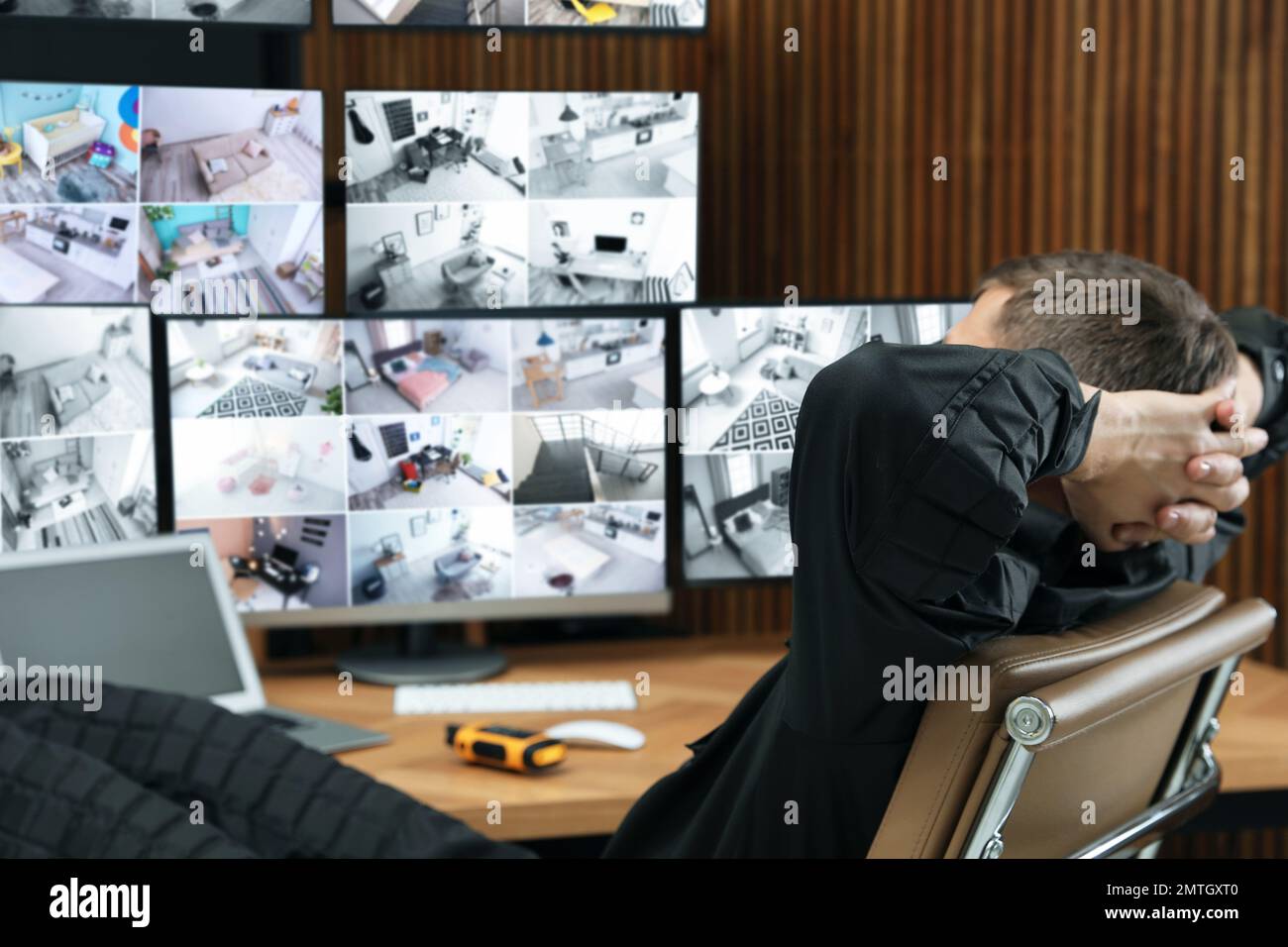 Tired security guard sleeping at workplace in office Stock Photo - Alamy