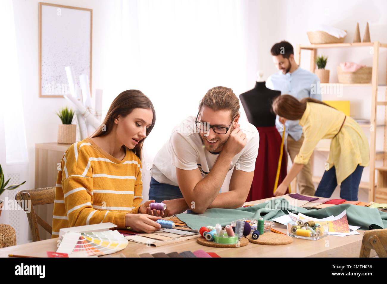 Fashion designers creating new clothes in studio Stock Photo - Alamy