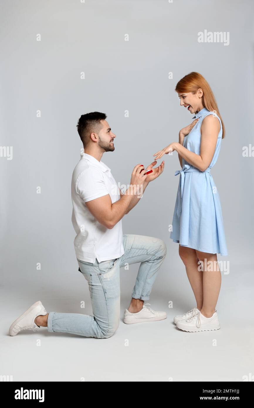 Man with engagement ring making marriage proposal to girlfriend on ...