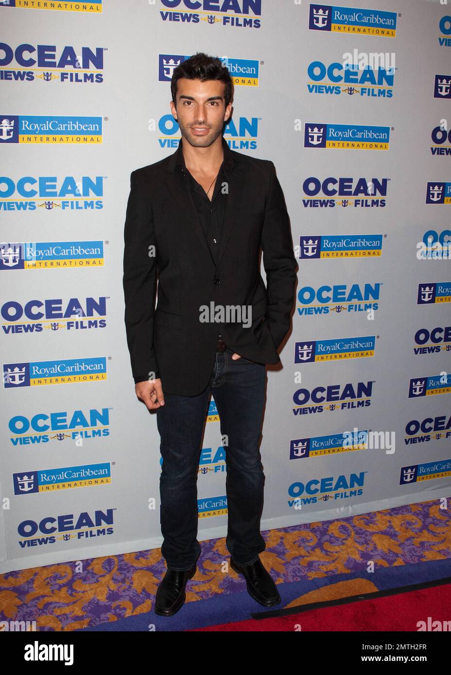 Justin Baldoni poses for photographers aboard the Allure of the Seas ...