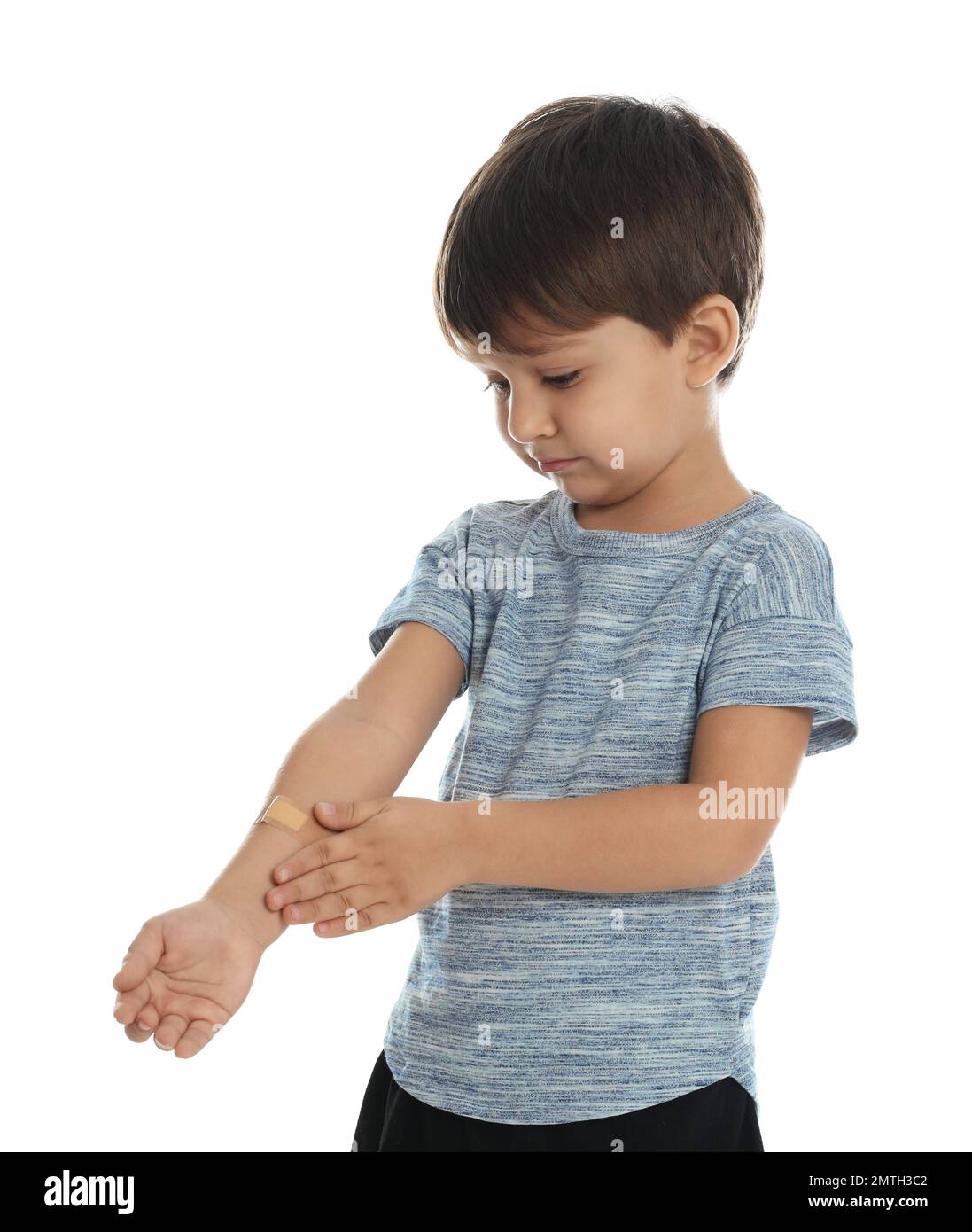 Little boy with sticking plaster on arm against white background Stock ...