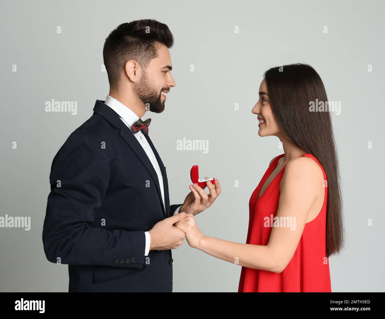 Man with engagement ring making marriage proposal to girlfriend on ...
