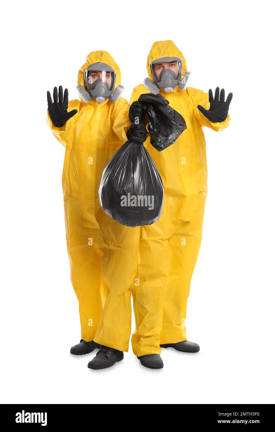 Man and woman in chemical protective suits with trash bag on white ...