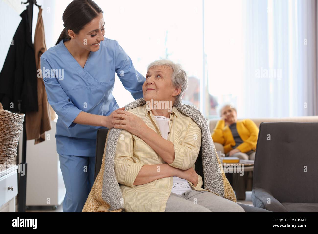 Nurse taking care of elderly woman in geriatric hospice Stock Photo - Alamy