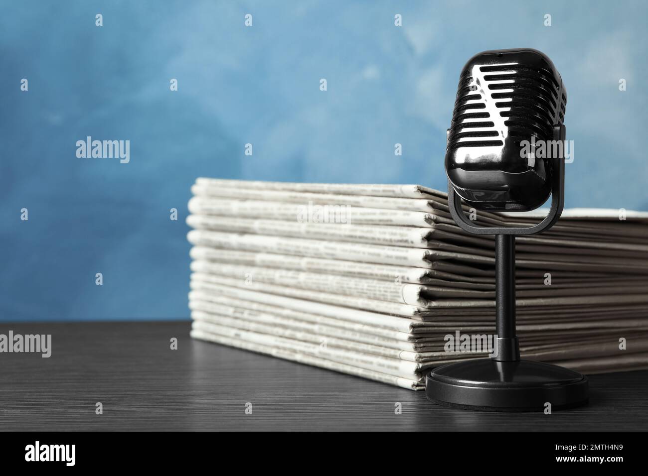 Newspapers and vintage microphone on table. Journalist's work Stock ...