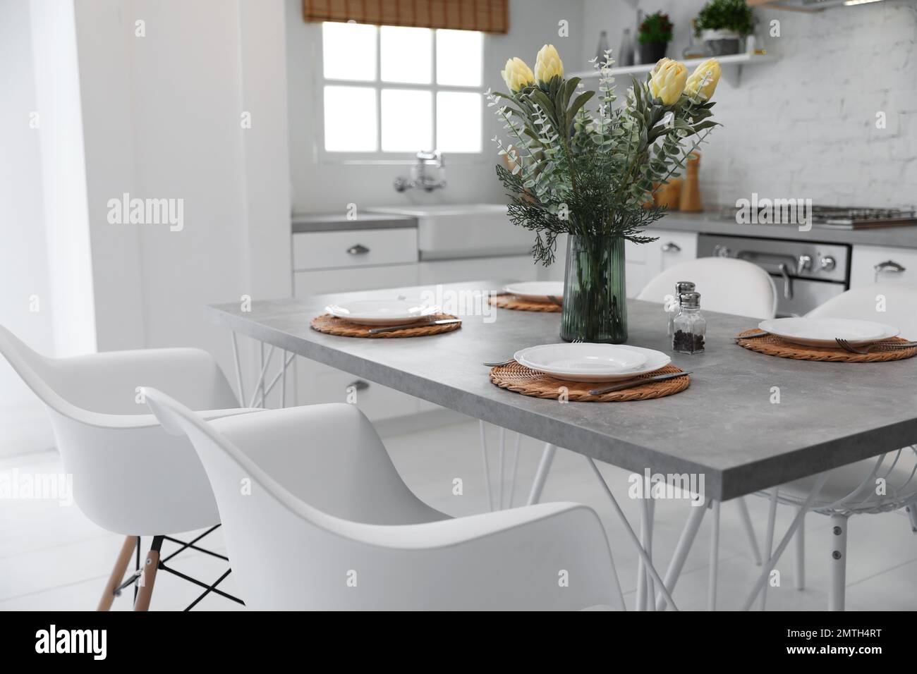 Elegant table setting in stylish kitchen. Interior design Stock Photo ...
