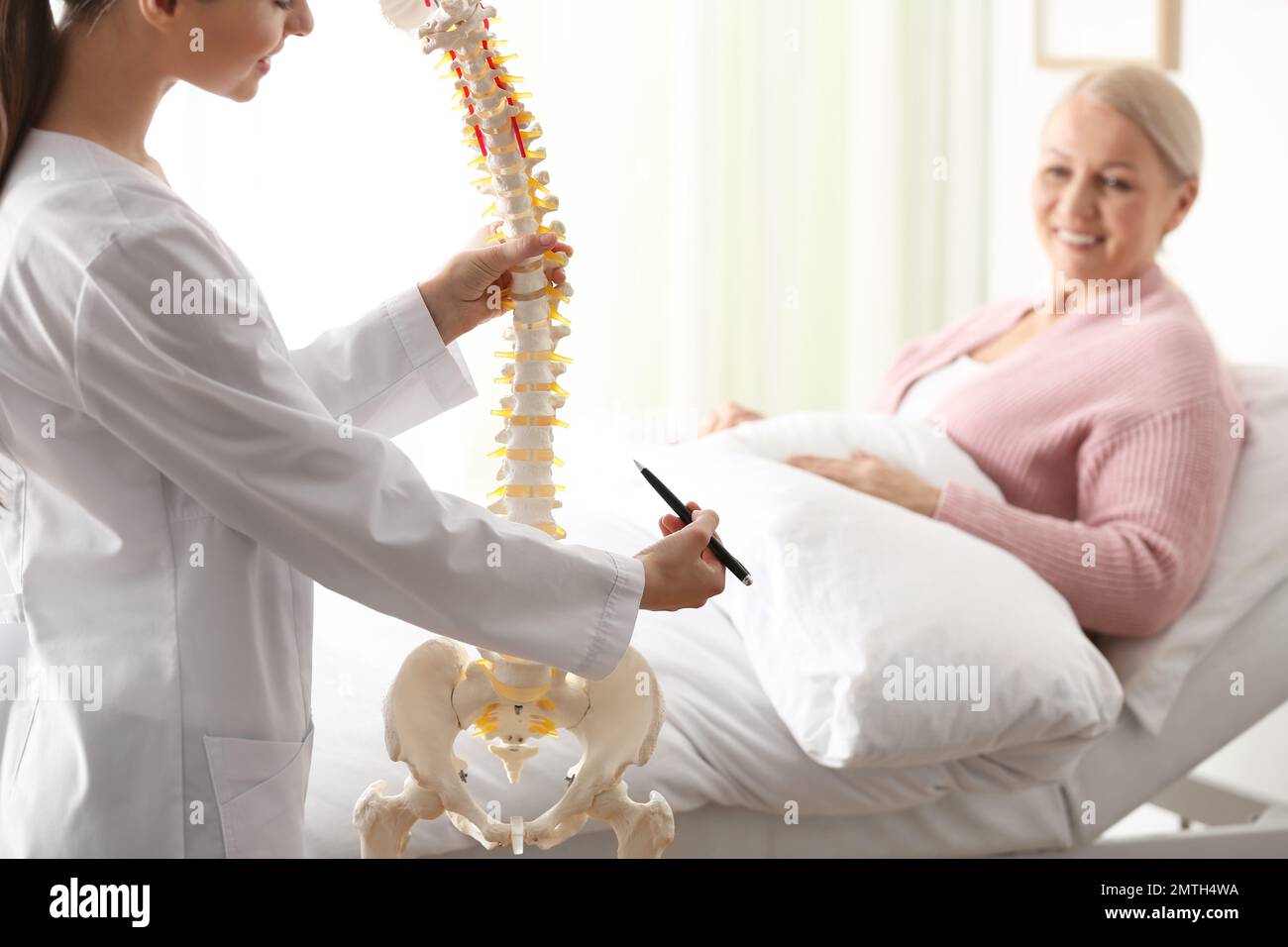 Orthopedist explaining structure spine hi-res stock photography and ...