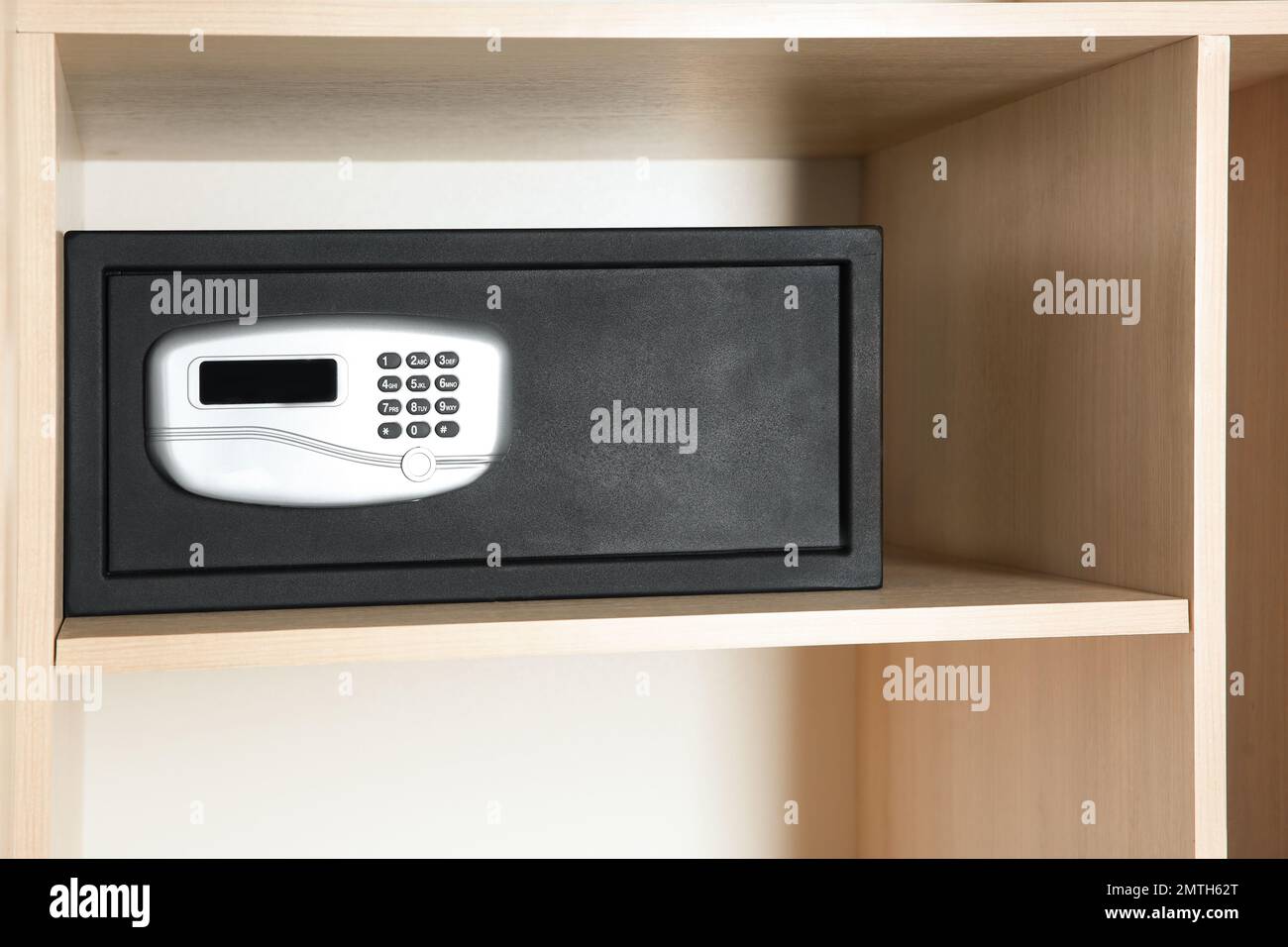 Black steel safe with electronic lock in wooden closet Stock Photo - Alamy