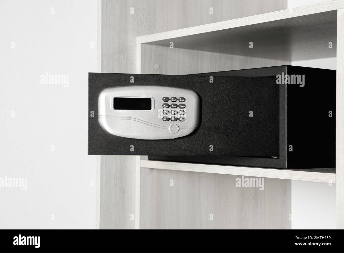 Black steel safe with electronic lock in wooden closet Stock Photo - Alamy