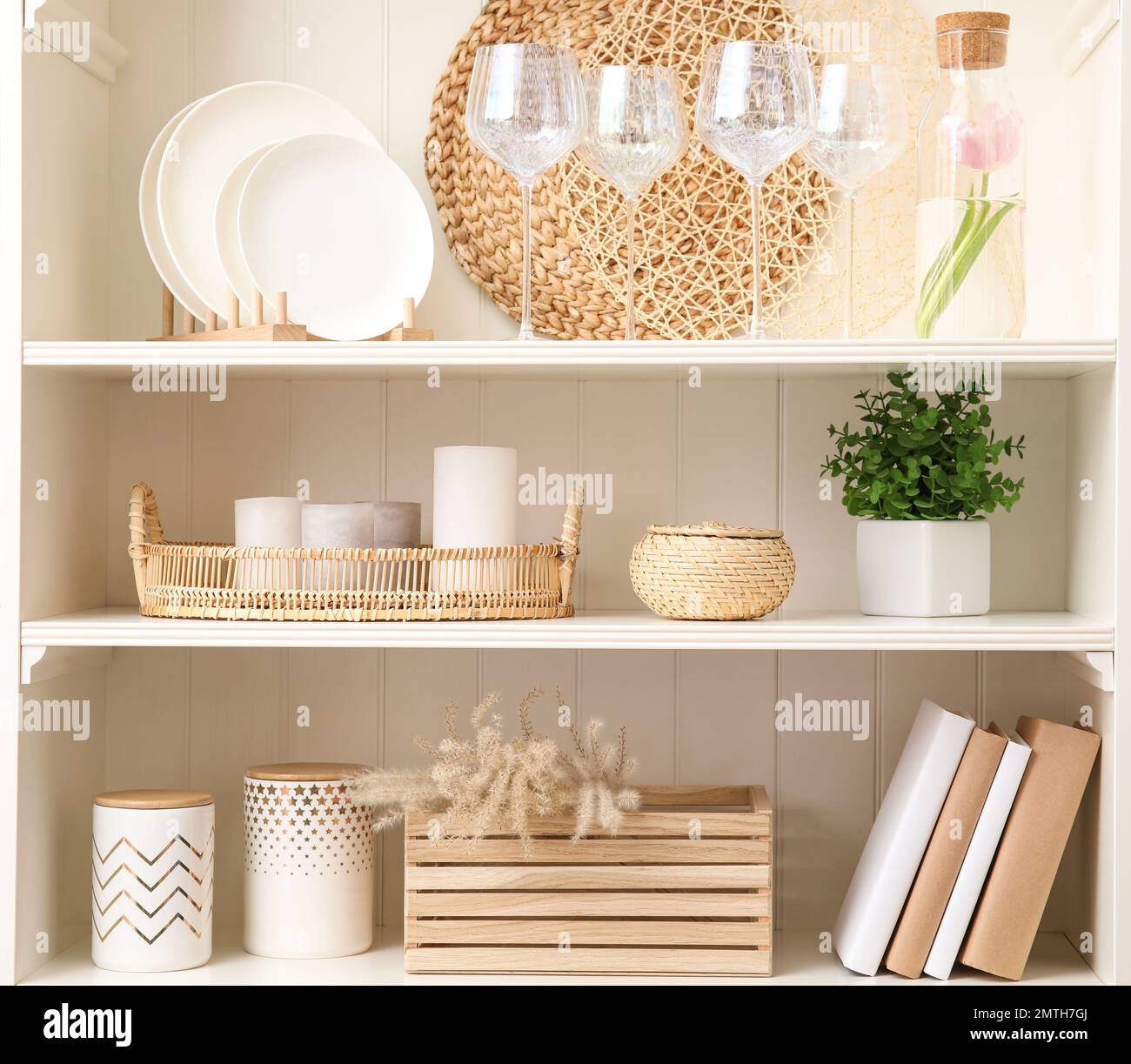 White shelving unit with dishware and different decorative stuff Stock ...