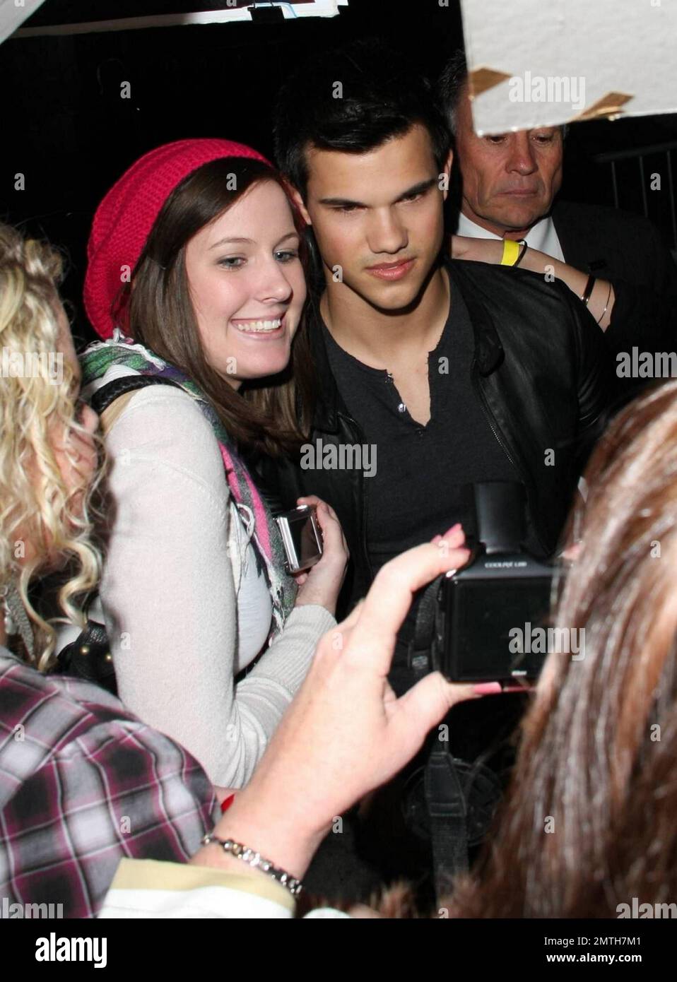Taylor Lautner poses for photos and signs autographs as he arrives at ...