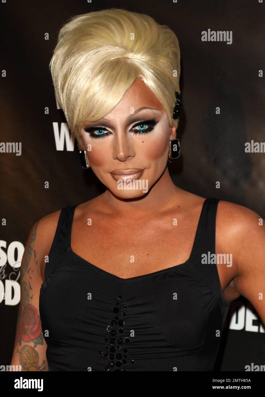 Drag queen Raven poses for photographers on the red carpet at Rage ...