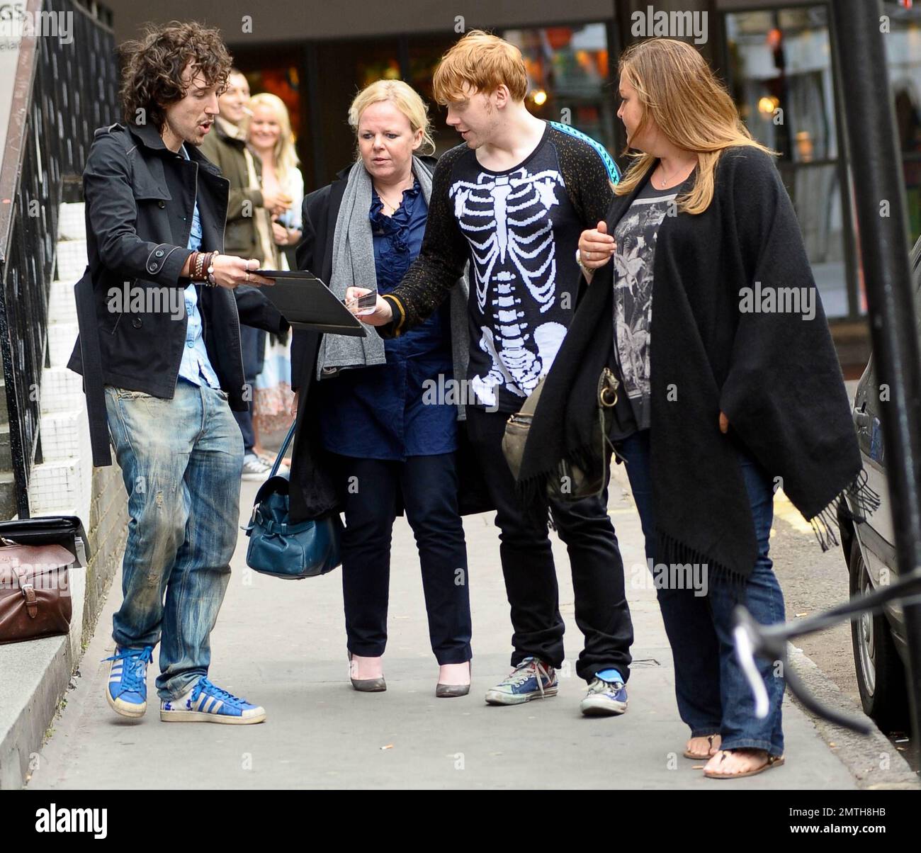 "Harry Potter" star Rupert Grint wears a skeleton sweater as he leaves ...