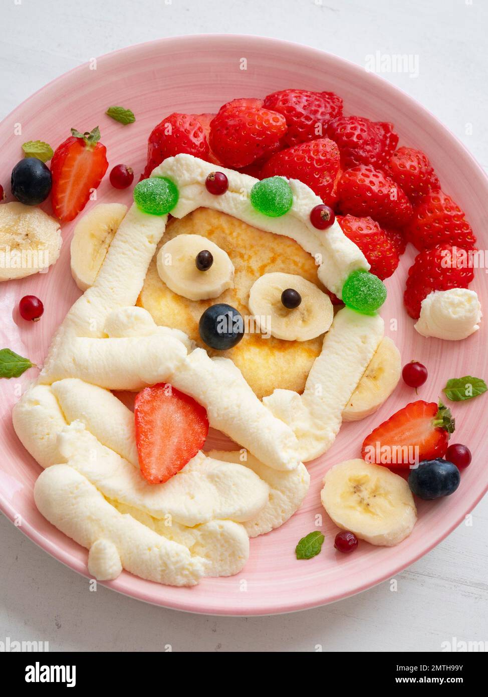 Santa Claus face with pancake and strawberries Stock Photo - Alamy
