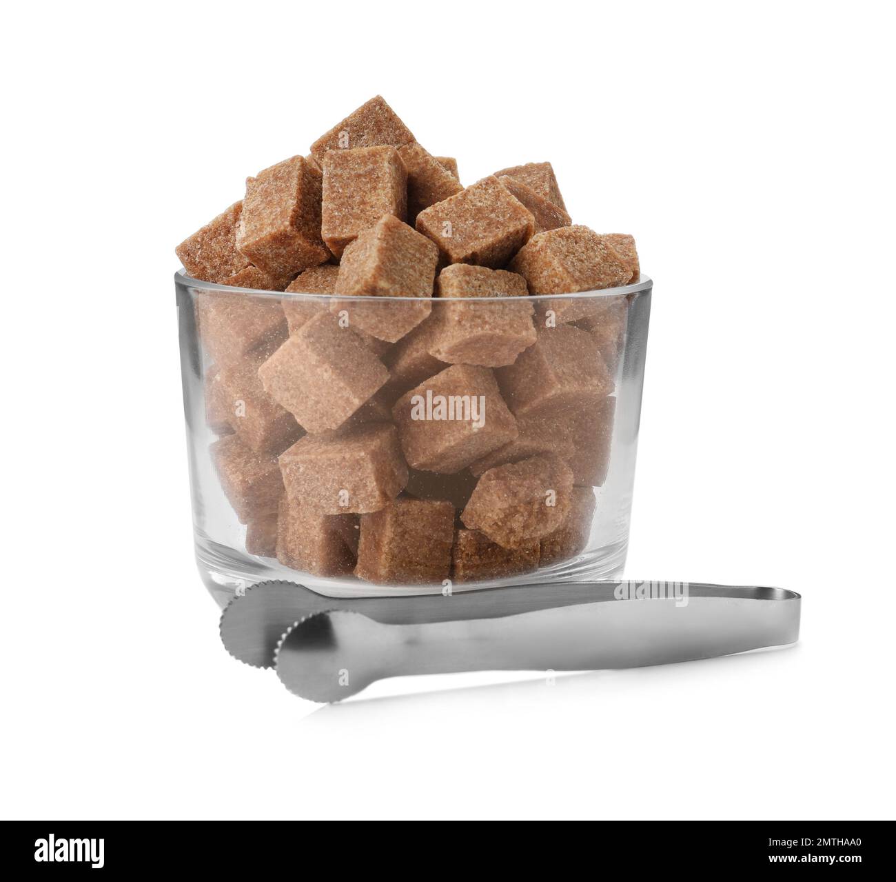 Glass bowl with brown sugar cubes and tongs isolated on white Stock ...