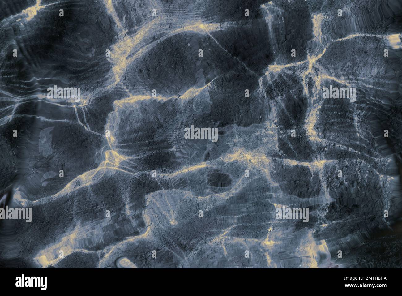 Abstract photo of the glow of the surface of transparent water. The ...