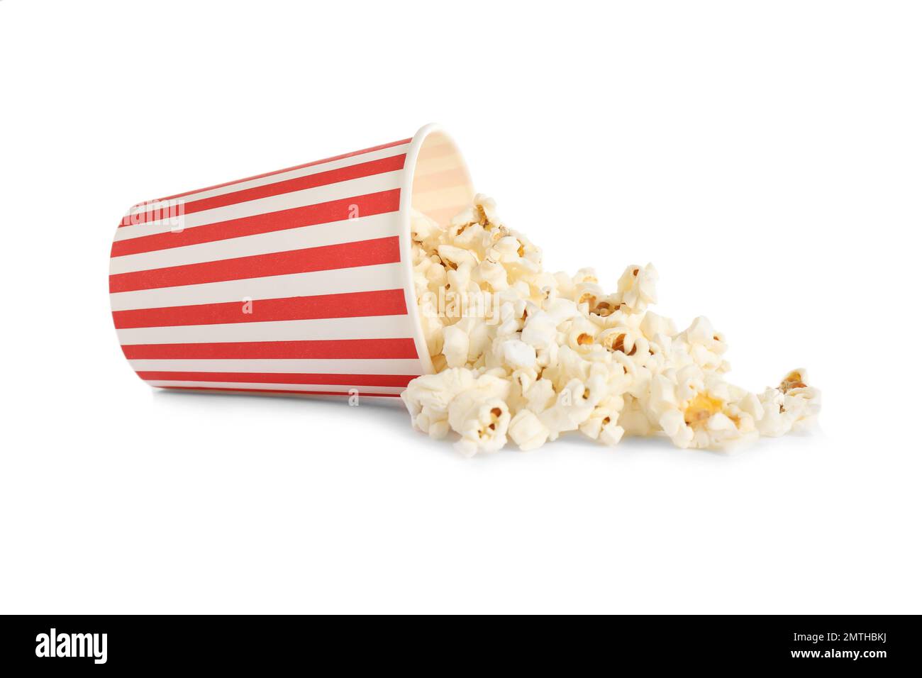 Overturned paper cup with delicious popcorn isolated on white Stock ...