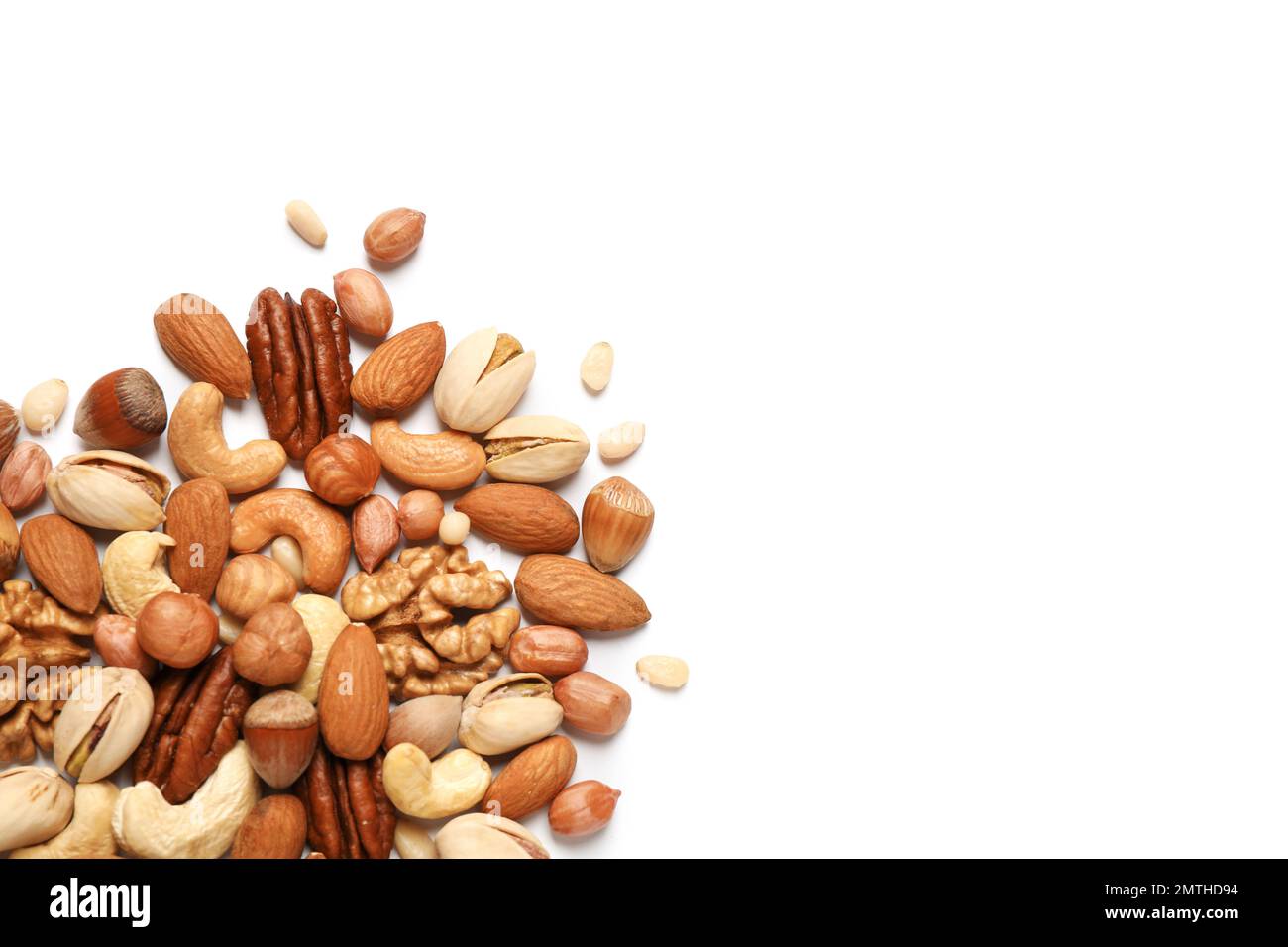 Different delicious nuts on white background, flat lay. Space for text ...