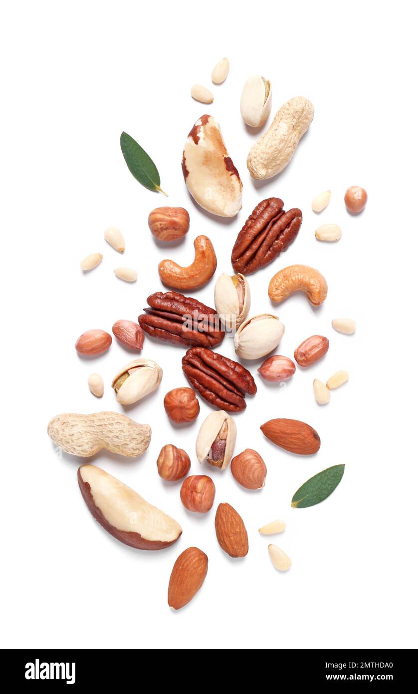 Different delicious nuts on white background, flat lay Stock Photo - Alamy