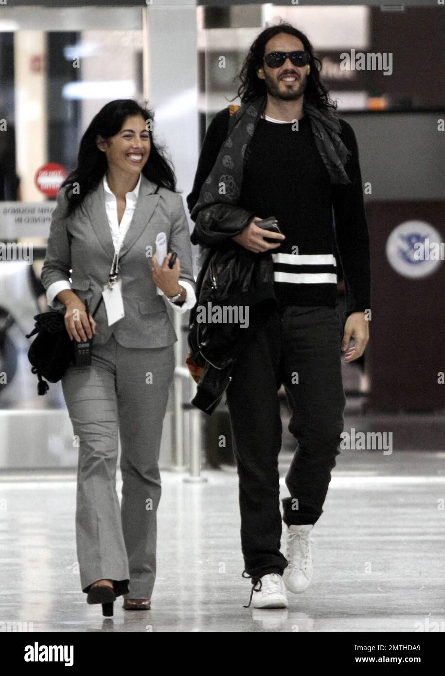 EXCLUSIVE!! English actor Russell Brand wears ear plugs as he arrives ...