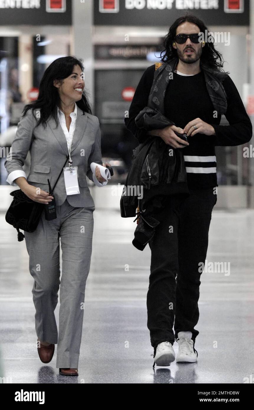 EXCLUSIVE!! English actor Russell Brand wears ear plugs as he arrives ...