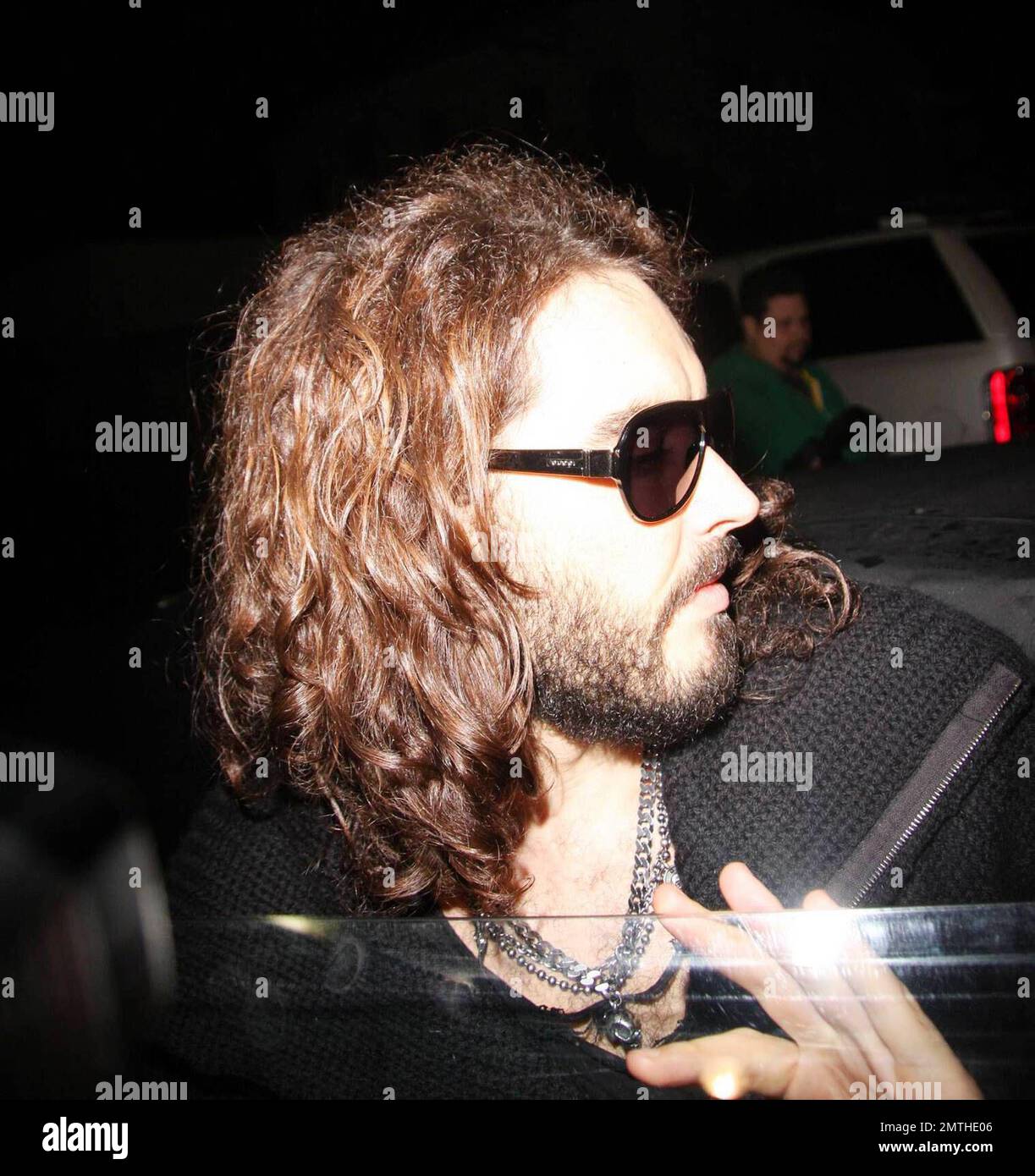 Disgraced UK comedian Russell Brand leaves via the back door of the ...