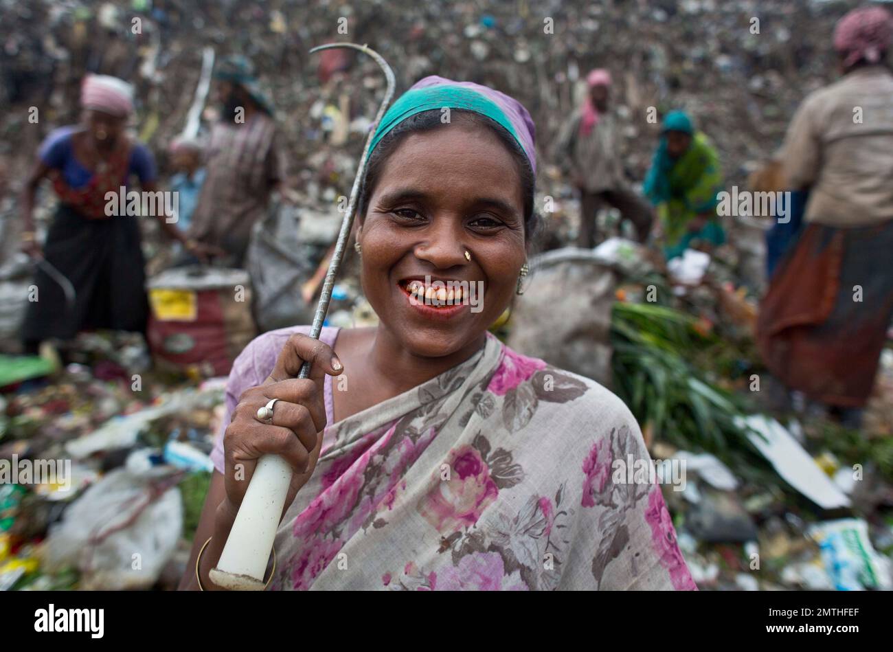 Sanuwara Beghum, an Indian ragpicker woman smiles to the camera as she ...