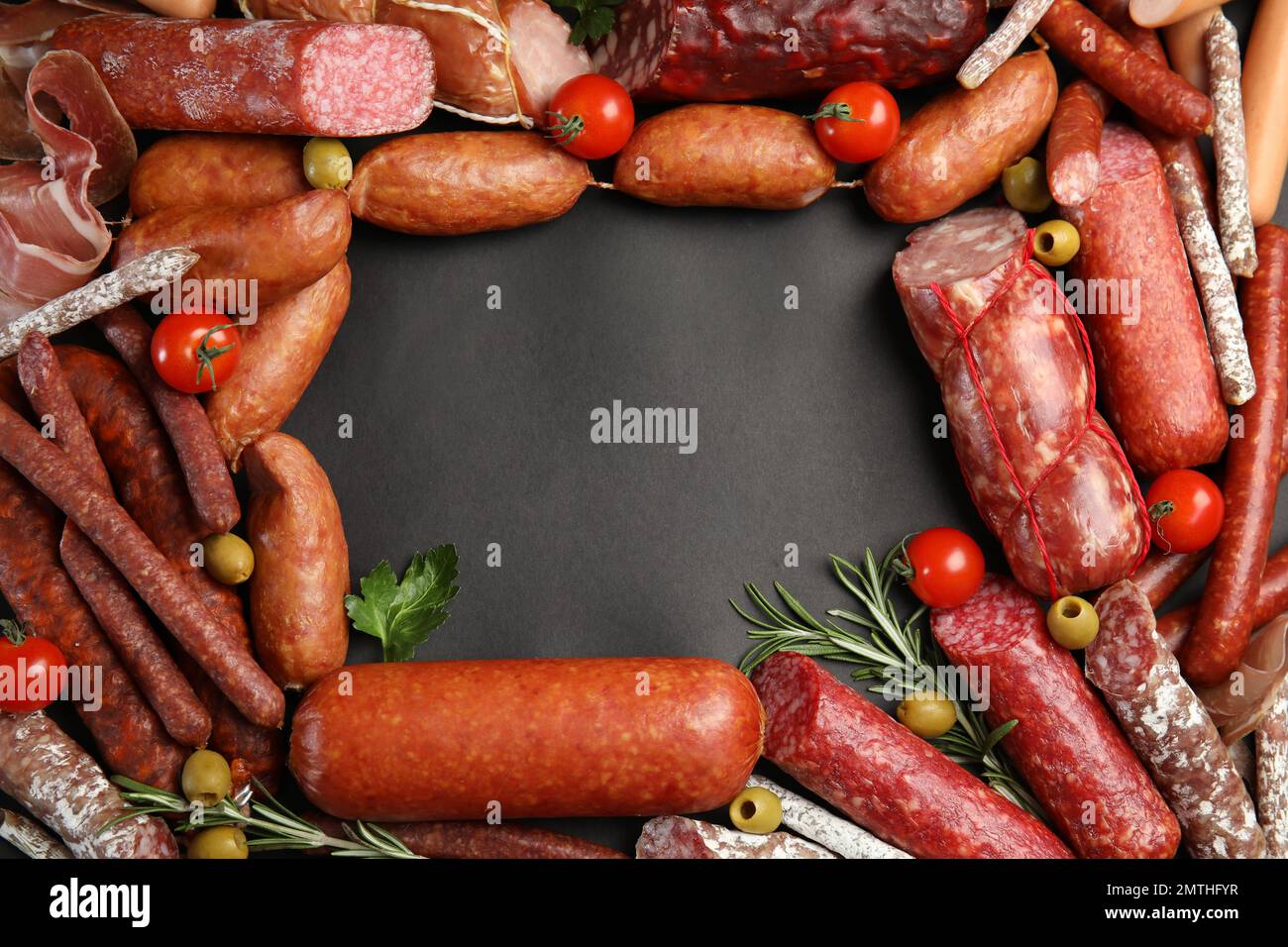 Frame made of different sausages on black background, flat lay. Space ...