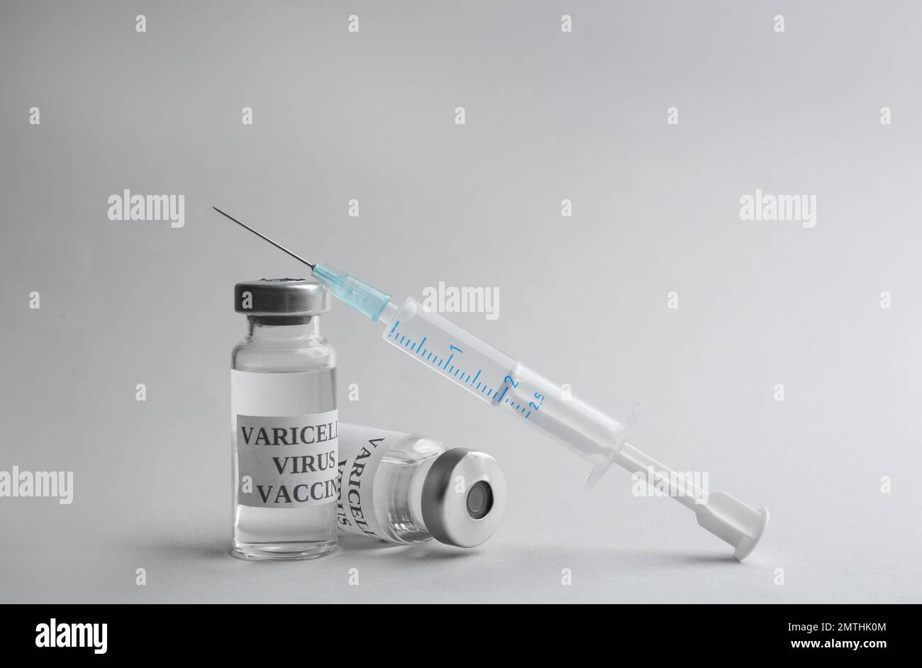 Chickenpox vaccine and syringe on light grey background. Varicella ...