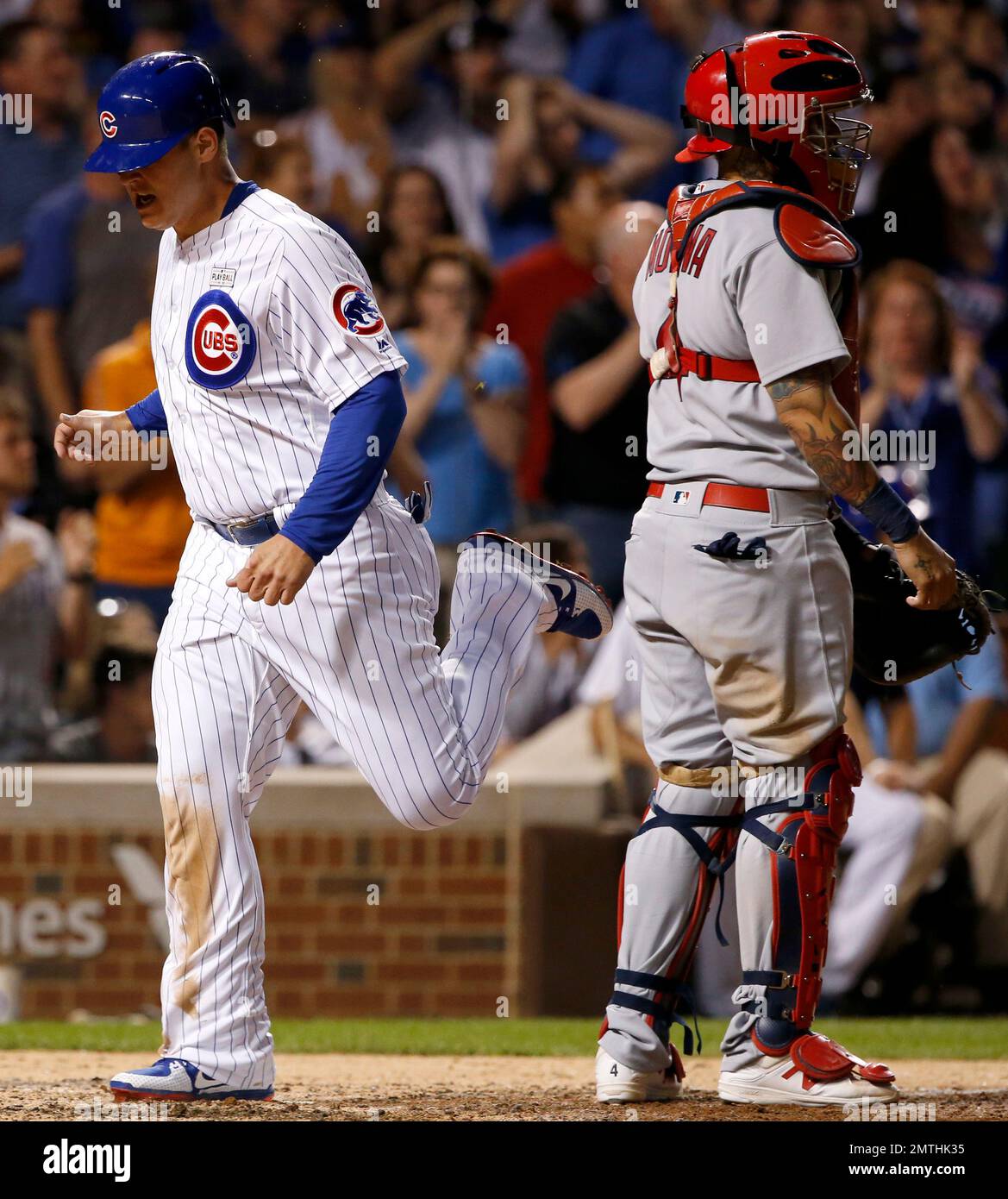 Chicago Cubs' Anthony Rizzo, left, scores on a single by Jon Jay as St ...