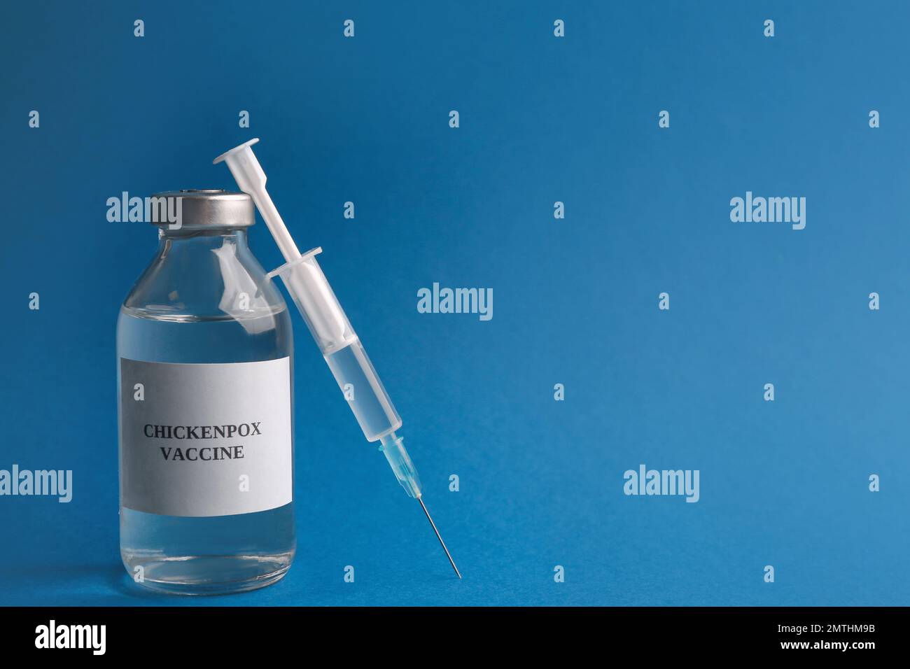 Chickenpox vaccine and syringe on blue background, space for text ...